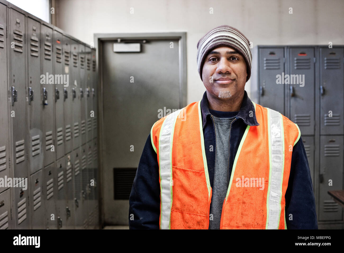 Black man factory worker standing next to lockers in a factory break ...