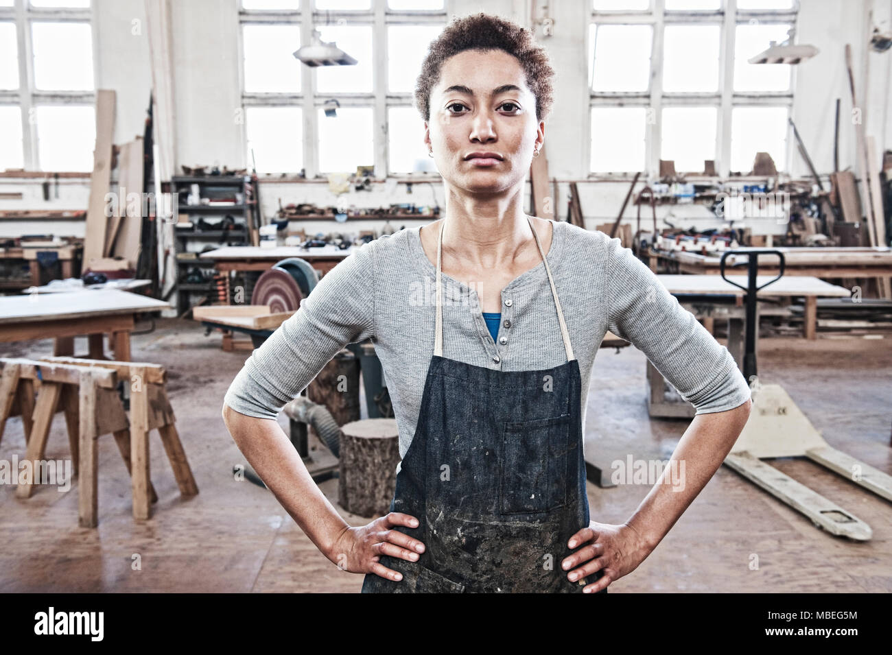 View of a black woman factory worker in a woodworking factory Stock ...