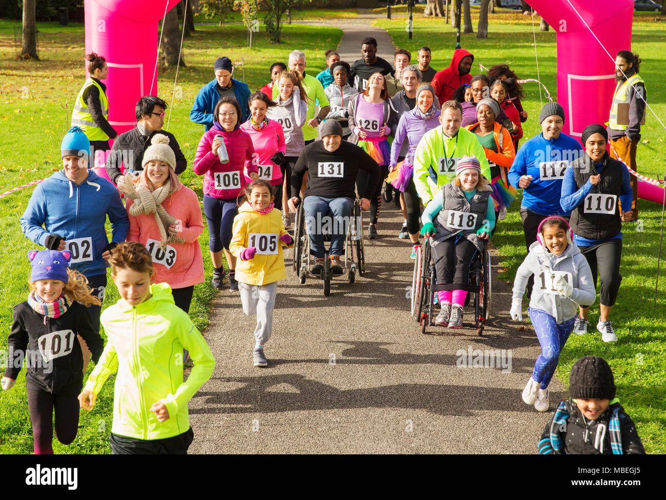 Crowd running at charity run in sunny park Stock Photo - Alamy
