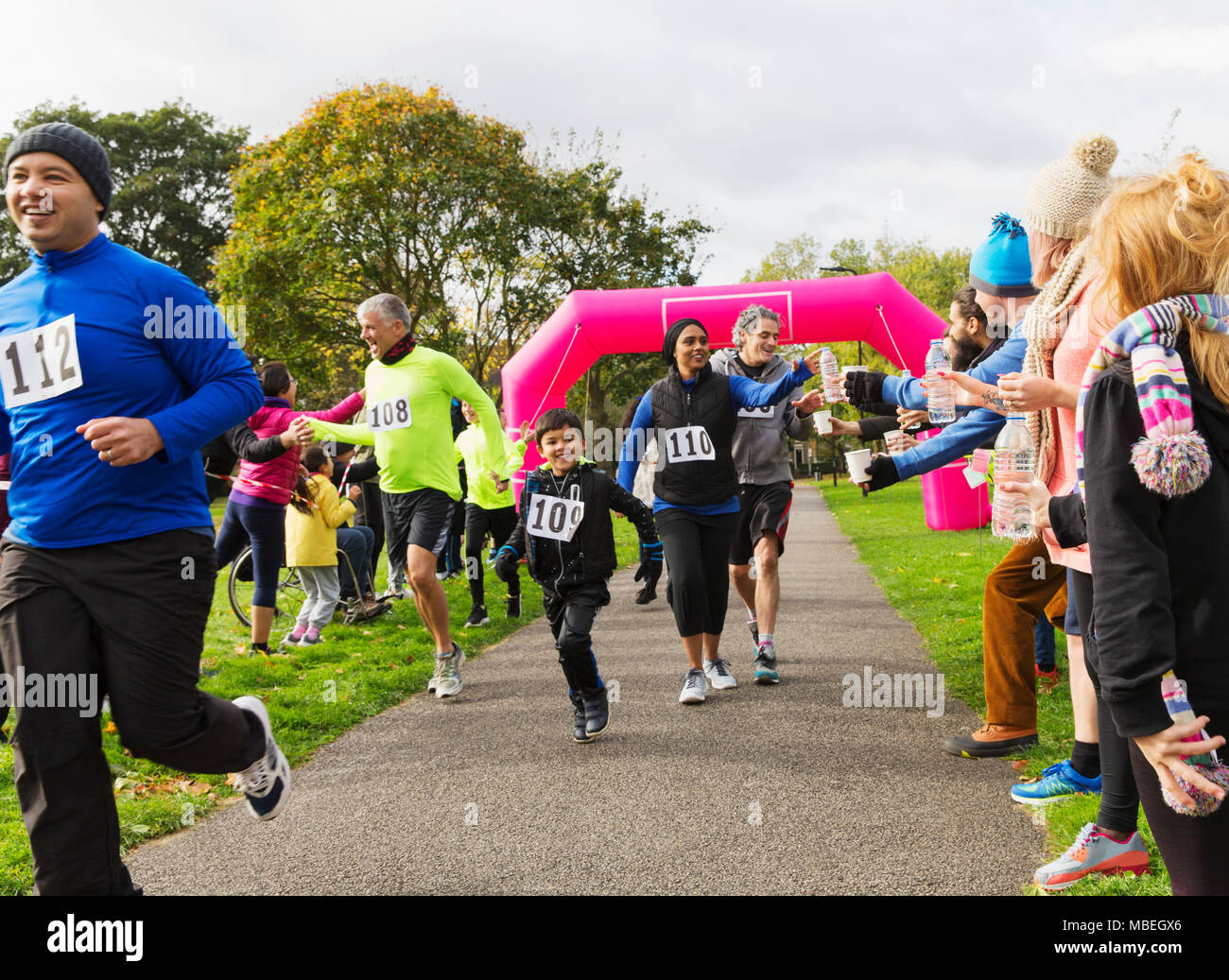 Running marathon reaching water hi-res stock photography and images - Alamy
