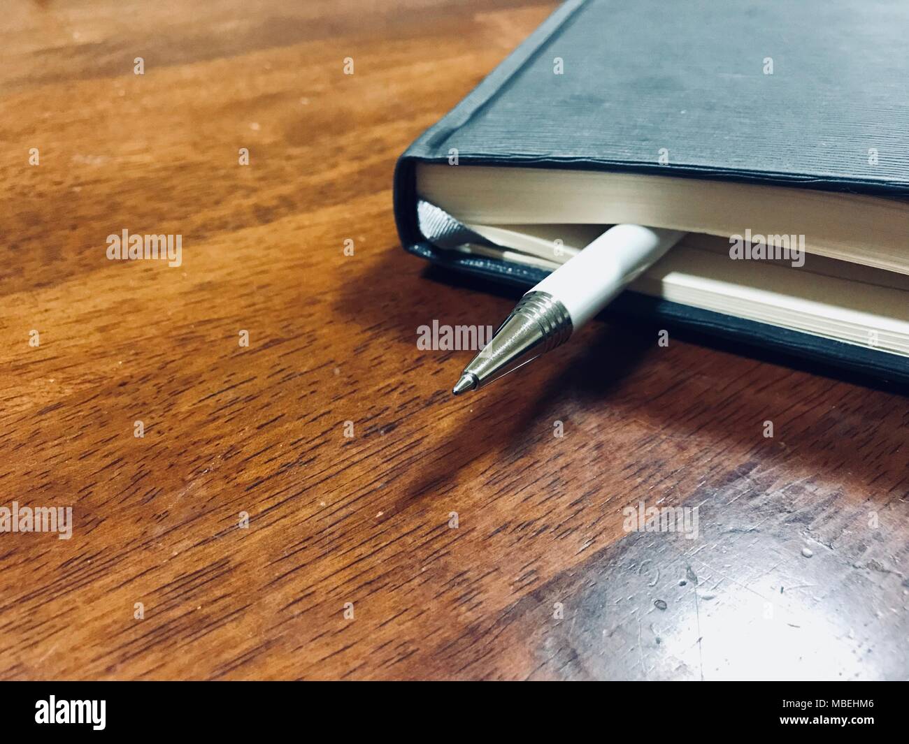 Pen is placed inside a book Stock Photo - Alamy