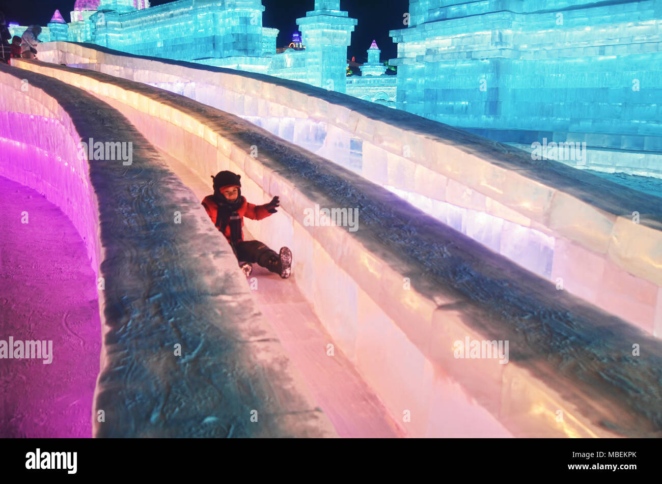 A child enjoys ice slide in Harbin Ice & Snow World Festival Stock Photo - Alamy