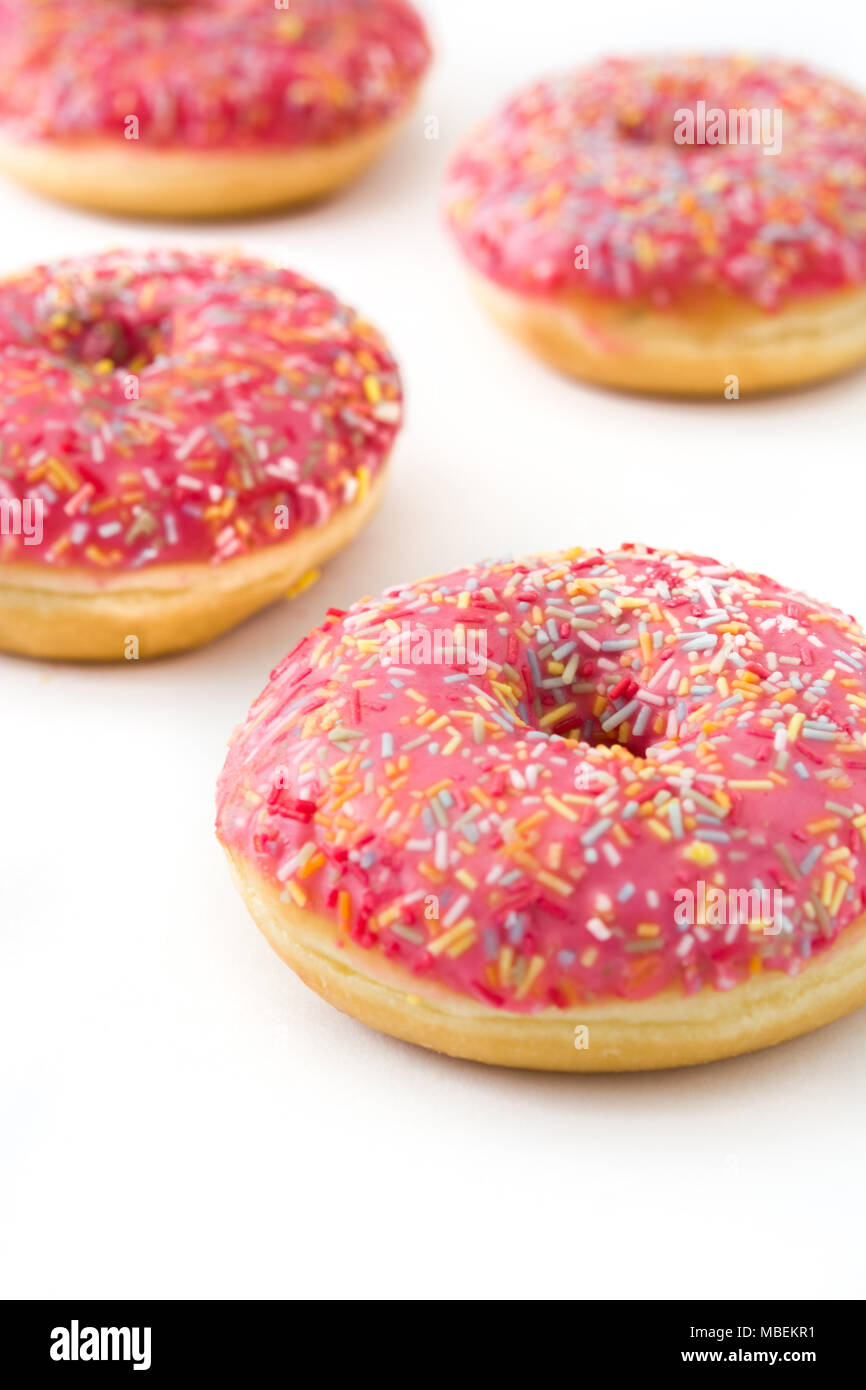 Pink frosted donut with colorful sprinkles isolated on white background ...