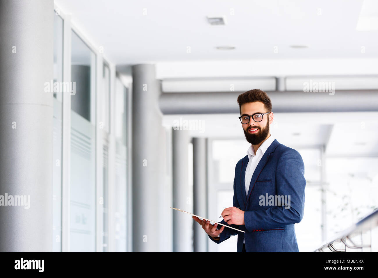 Young Businessman Posing While Writting On Some Paperwork Stock Photo ...