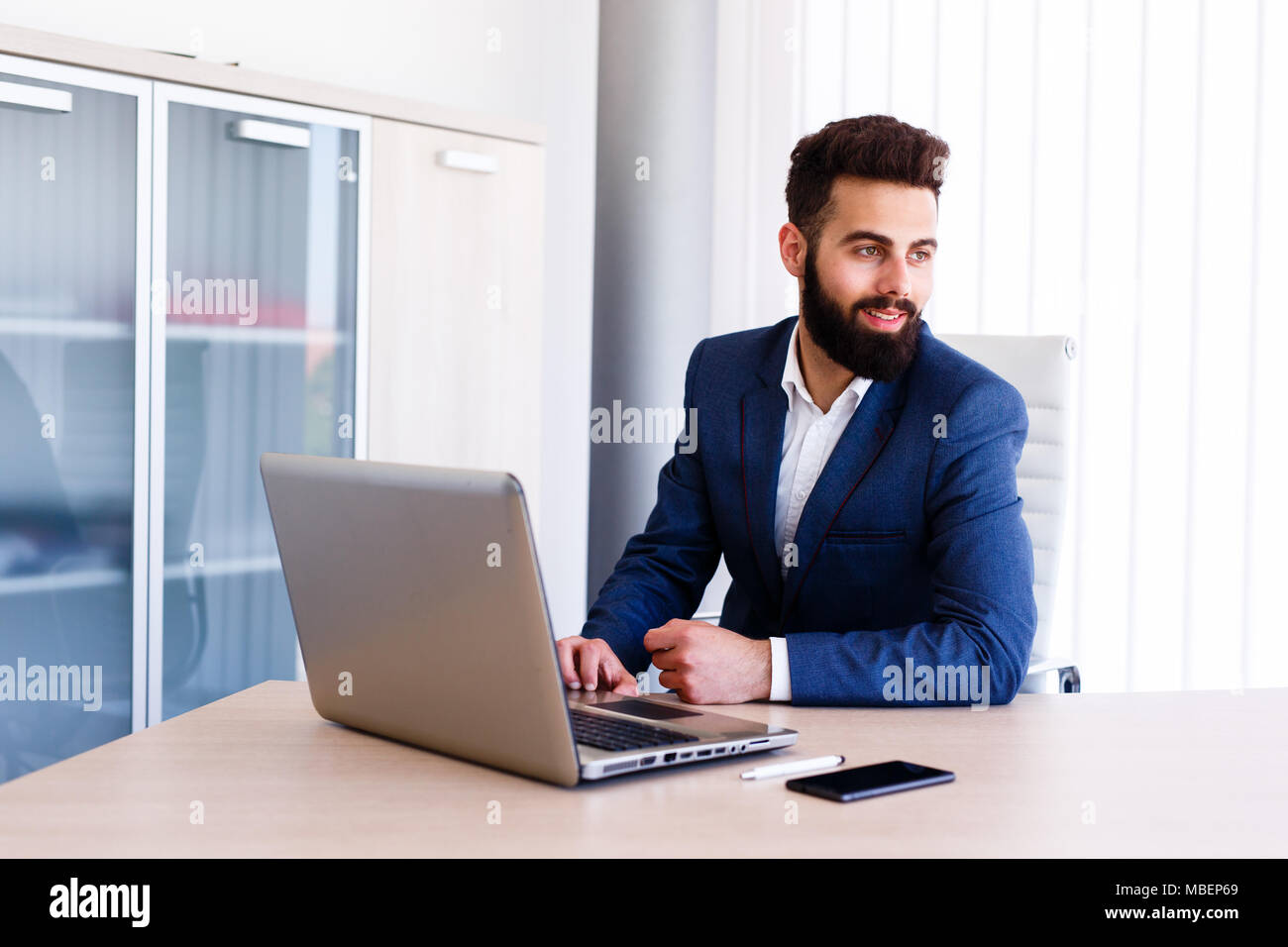 Sophisticated Young Businessman At Workplace Stock Photo - Alamy