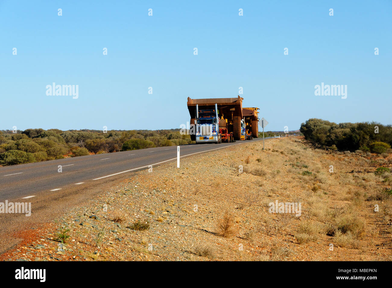 Oversized dump trucks being transported on the great northern highway ...
