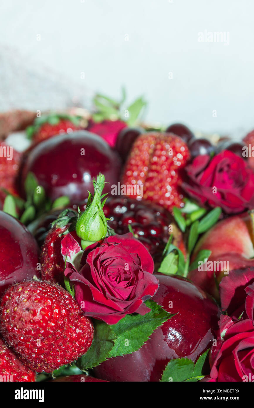 Bright red beautiful bouquet of fruits and flowers Stock Photo - Alamy