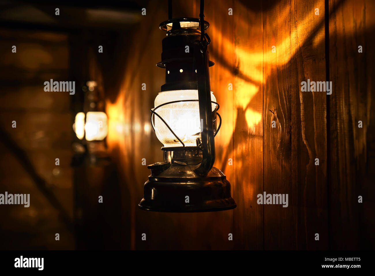 Beautiful light and shadows are reflected on the wooden wall from the ...