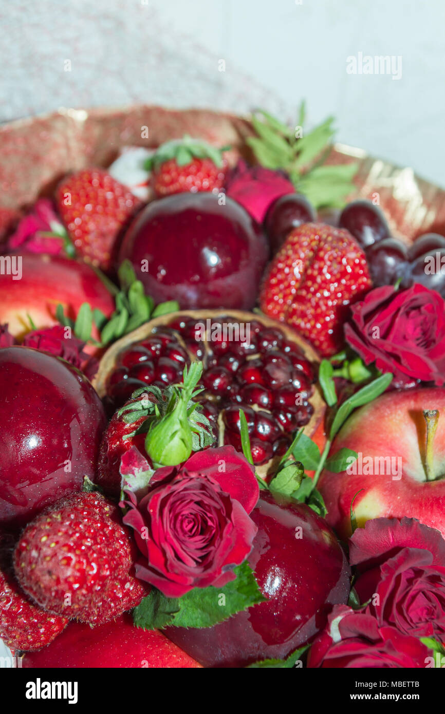 Bright red beautiful bouquet of fruits and flowers Stock Photo - Alamy