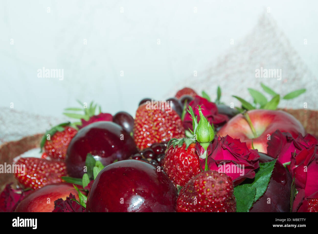 Bright red beautiful bouquet of fruits and flowers Stock Photo - Alamy