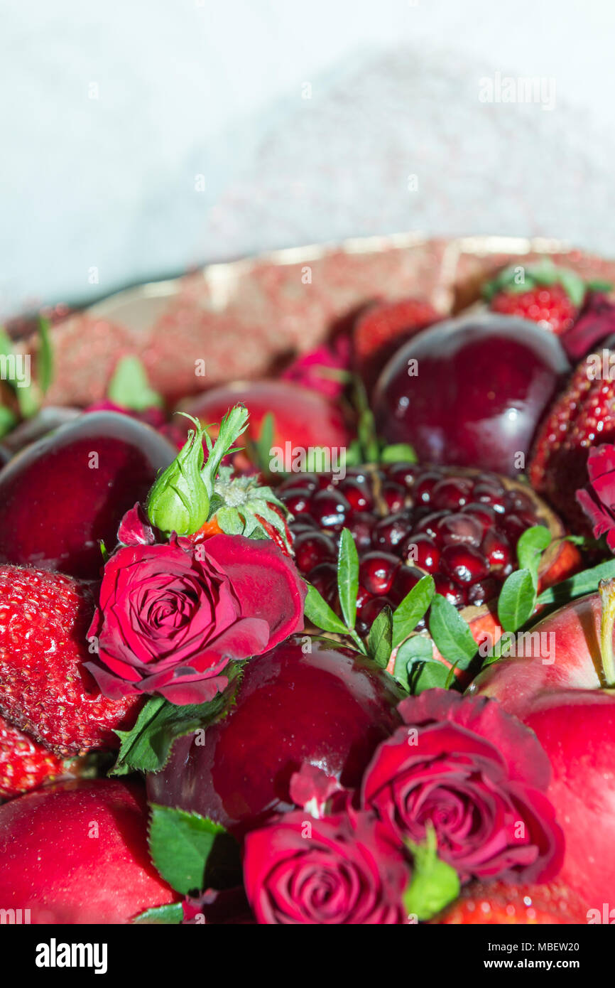 Bright red beautiful bouquet of fruits and flowers Stock Photo - Alamy