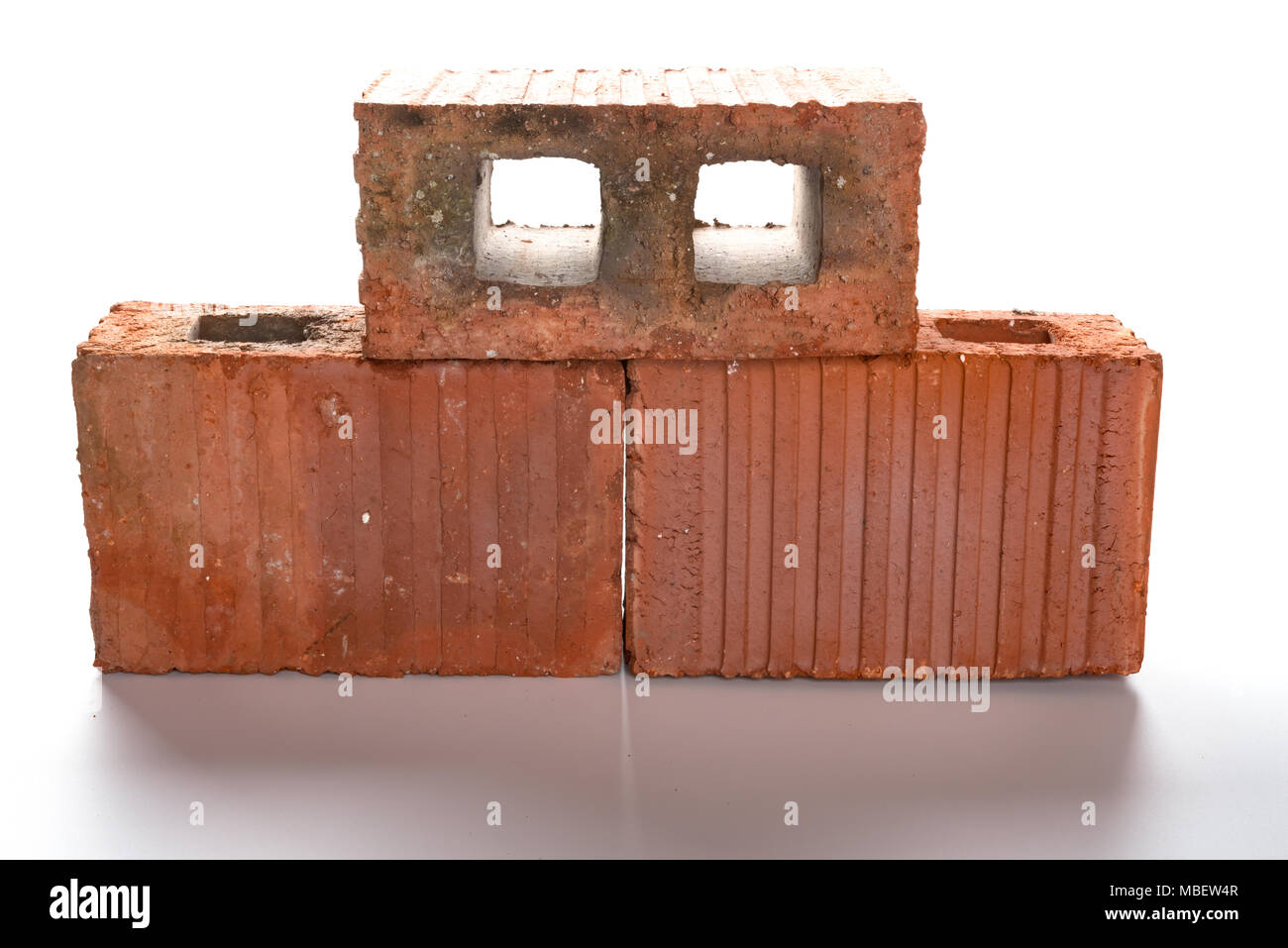 three bricks on a white background Stock Photo - Alamy