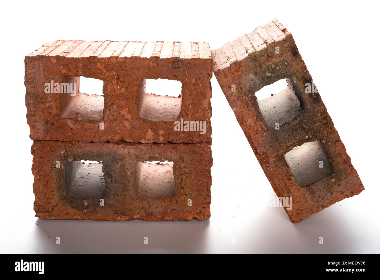 three bricks on a white background Stock Photo - Alamy