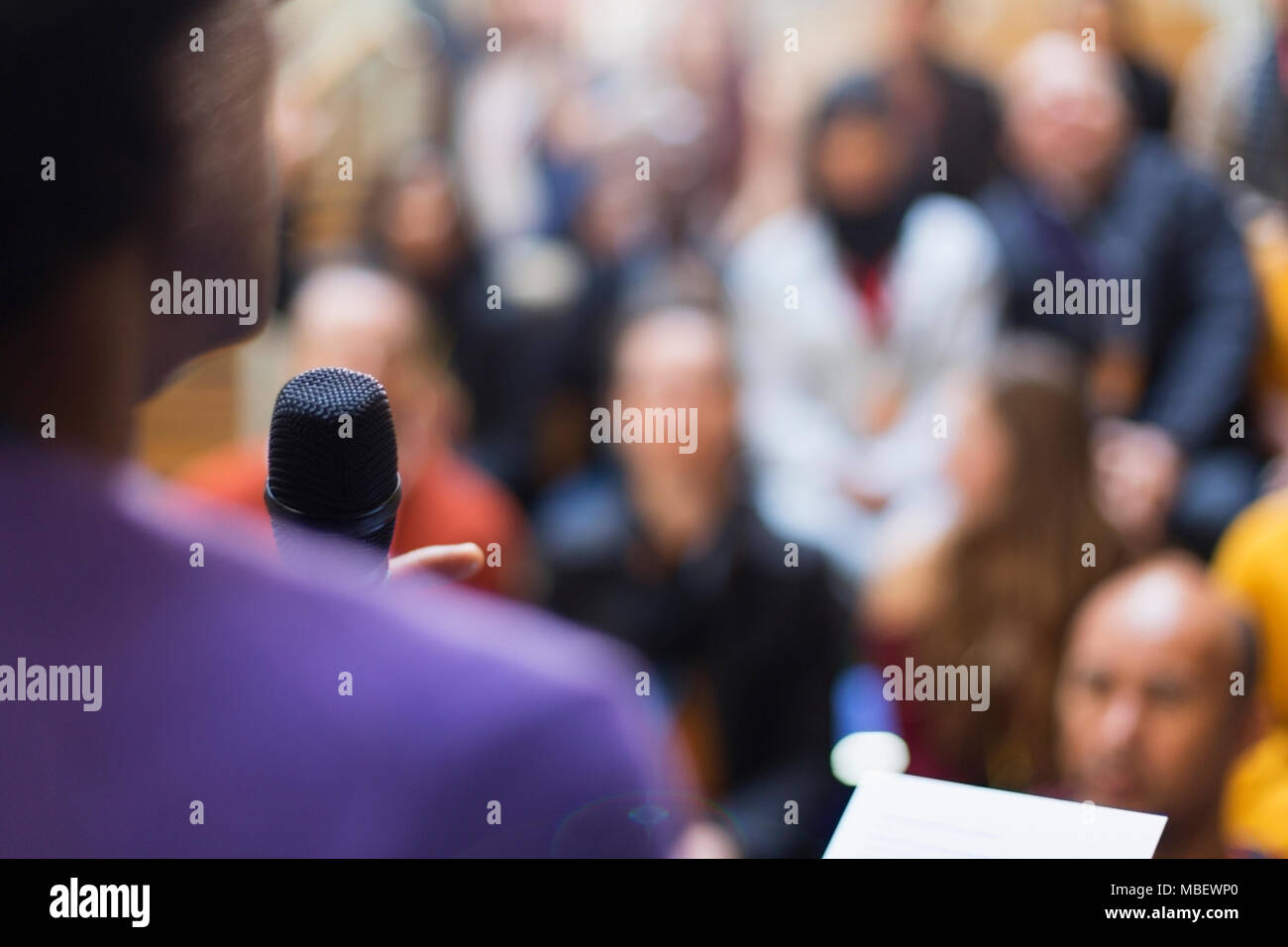 Businessman with microphone speaking to conference audience Stock Photo ...