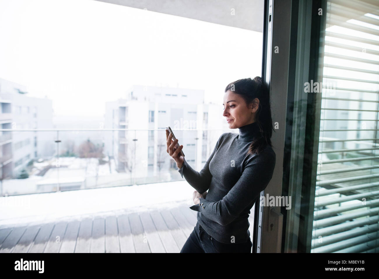 Standing woman holding smartphone hi-res stock photography and images ...