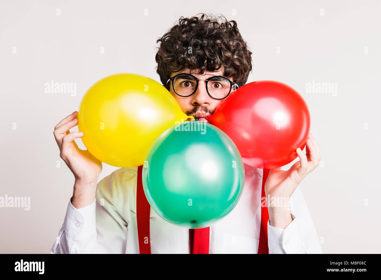 Man blowing up balloons hi-res stock photography and images - Alamy