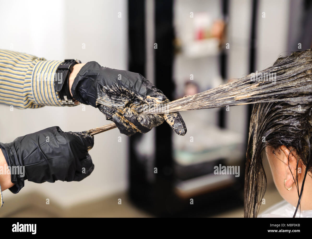 Beauty salon. Hairdresser dye hair of female client Stock Photo - Alamy