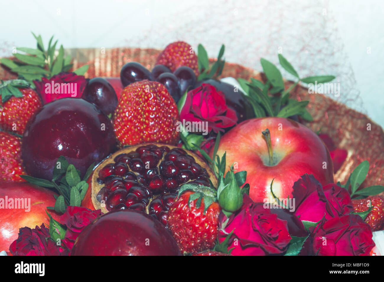 Bright red beautiful bouquet of fruits and flowers Stock Photo - Alamy