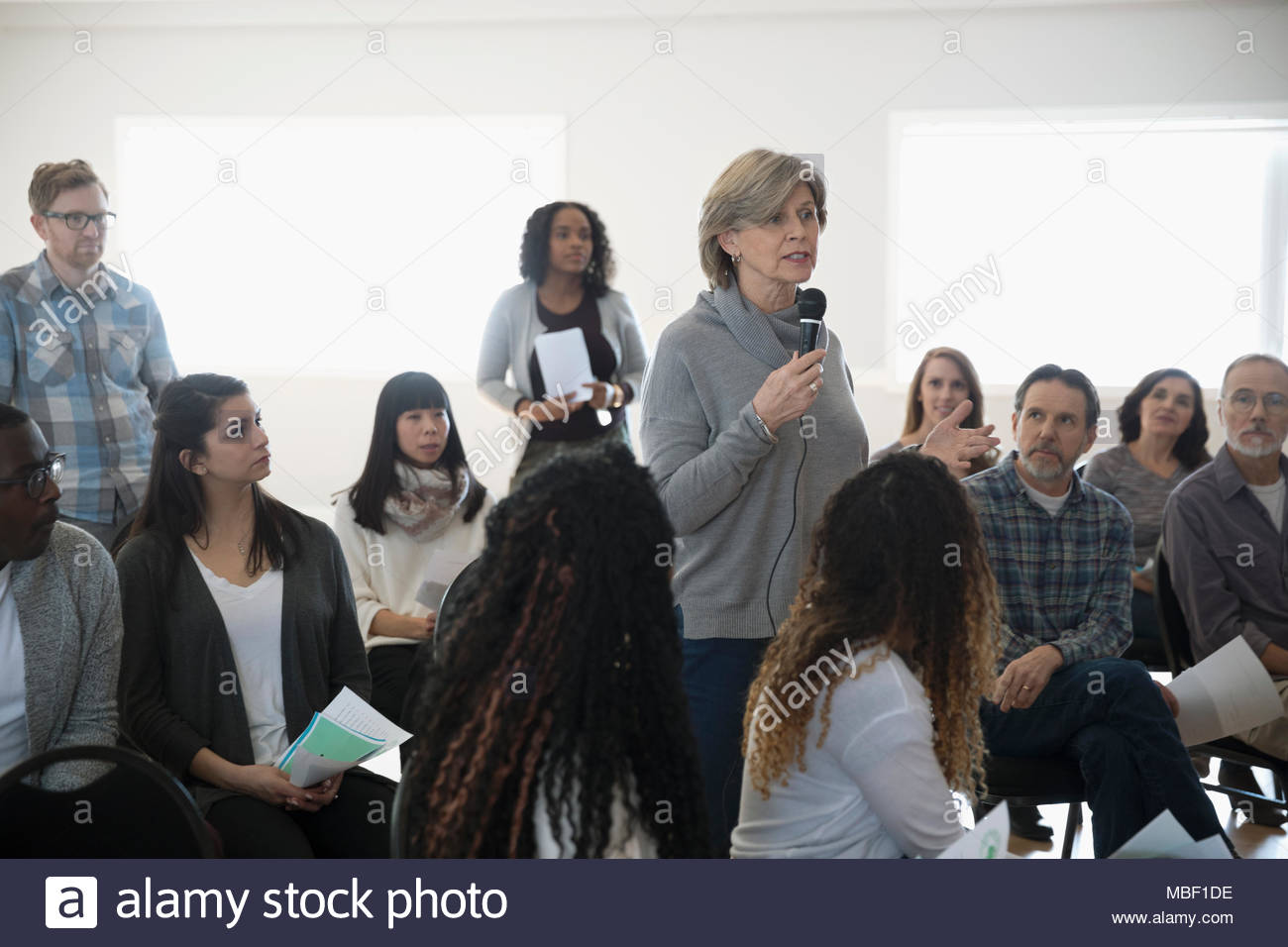 Woman speaking into microphone hi-res stock photography and images - Alamy
