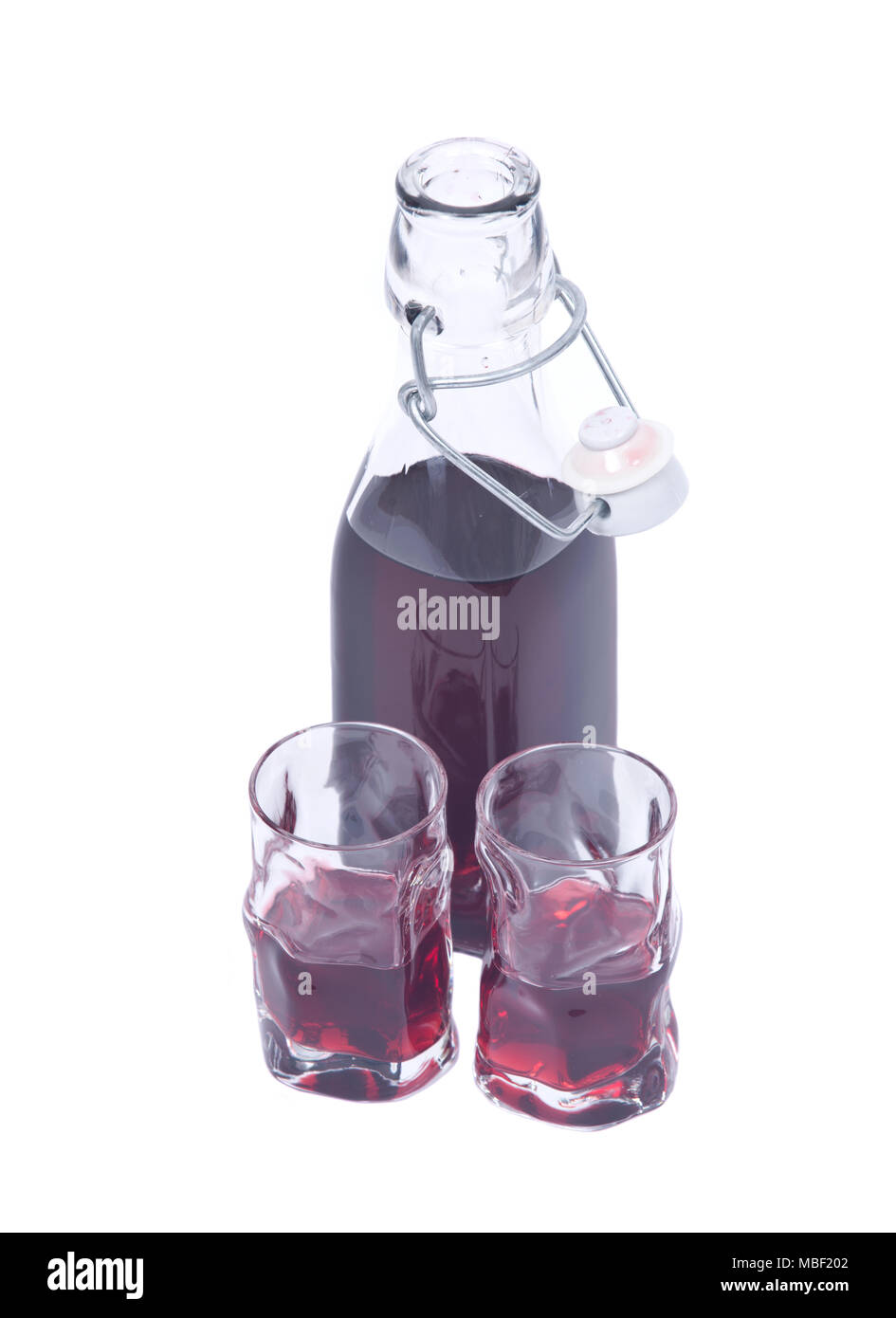 Homemade raspberry liqueur in clear glass bottle with swing top and ...