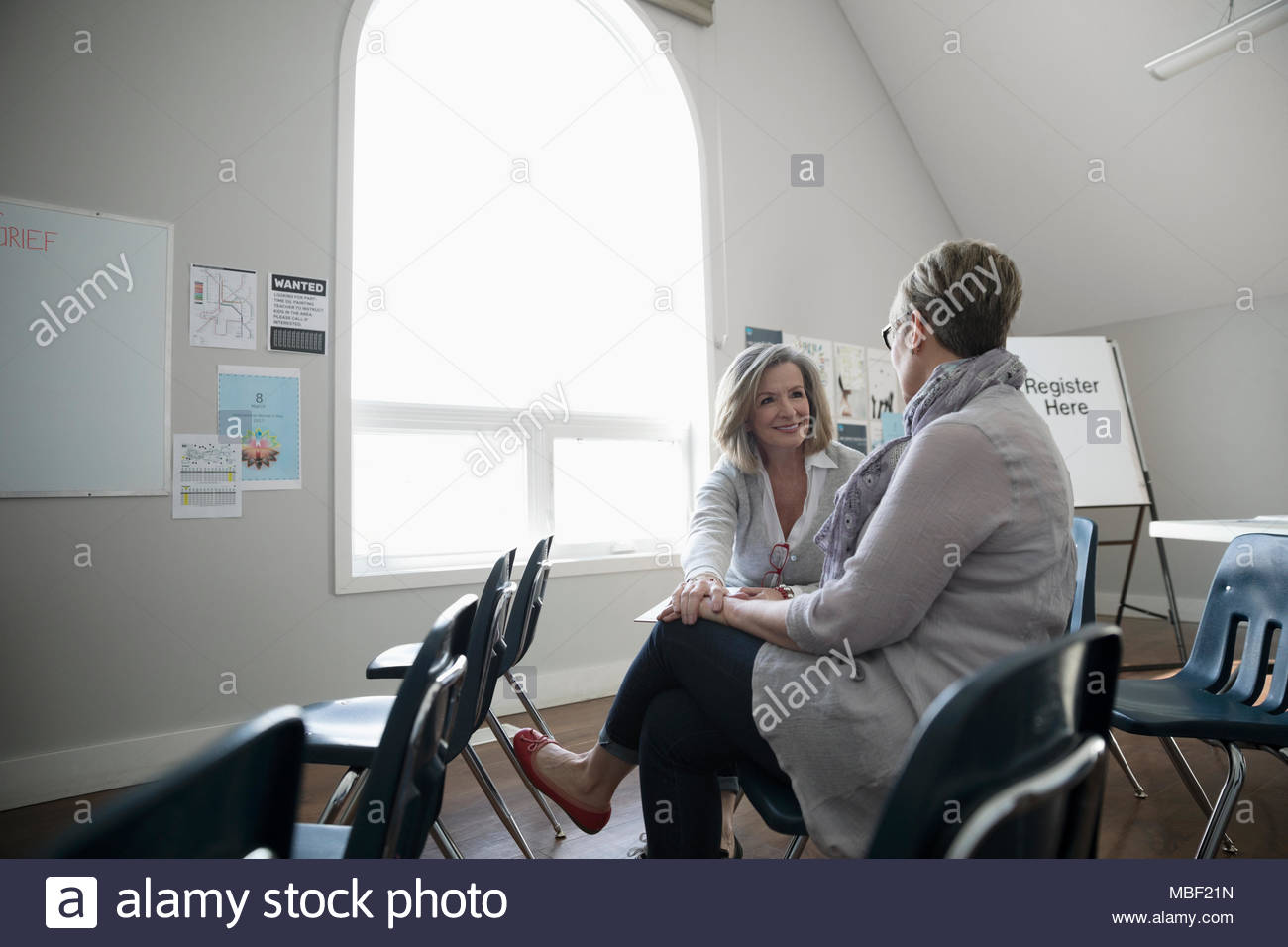 Women talking, comforting and supporting each other at support group in ...