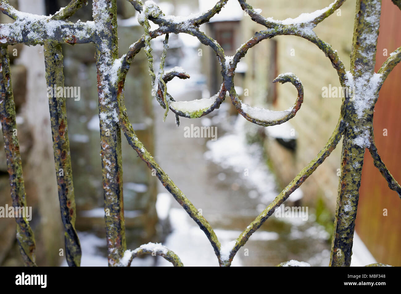Snow and ice rest on heart shaped rusting wrought iron gate. Nidderdale ...