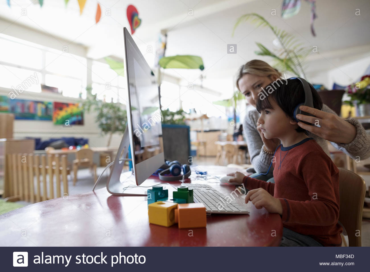 Boy student listening to teacher hi-res stock photography and images ...