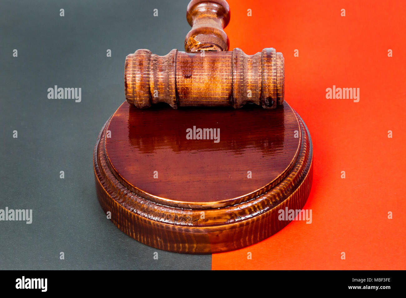 Wooden hammer with stand on a red - black background Stock Photo - Alamy