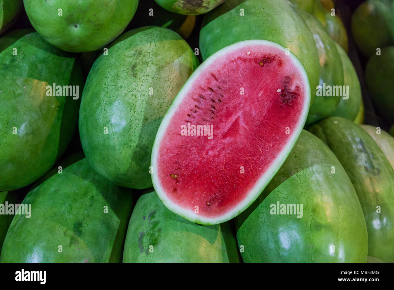 Open watermelon on some piled on the market Stock Photo - Alamy