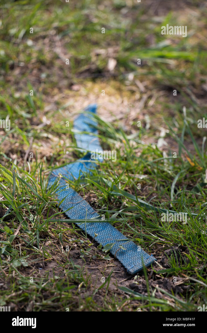 Broken strap from a bag, lying on the ground Stock Photo - Alamy