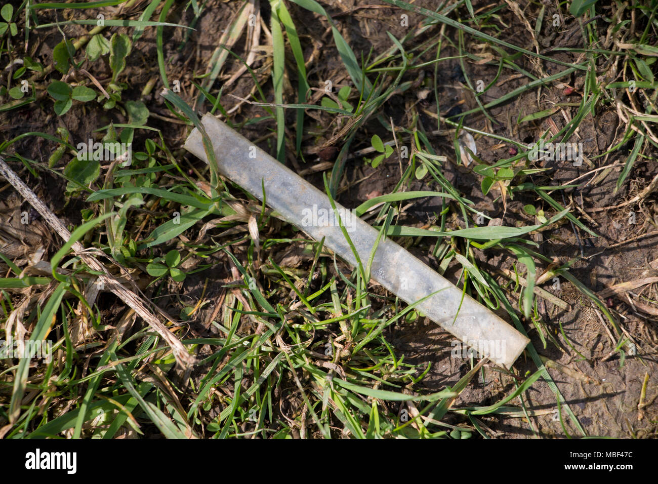 plastic litter on the ground Stock Photo - Alamy