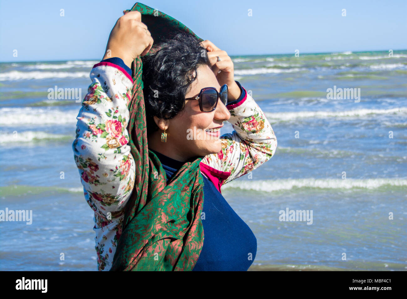 happy Iranian woman with easy hijab in beach of Caspian sea Stock Photo ...