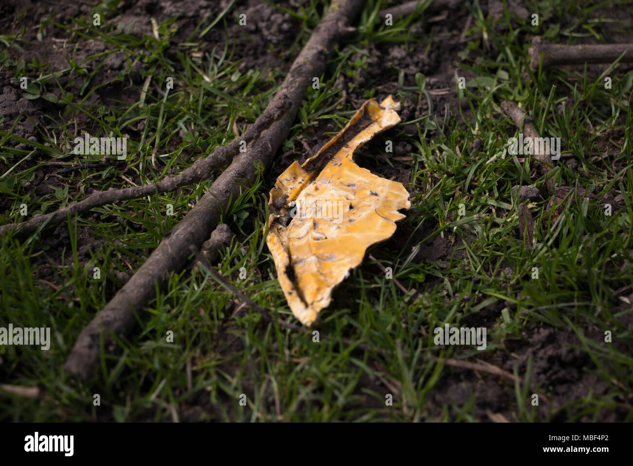 Broken yellow piece of plastic lying on the ground Stock Photo - Alamy