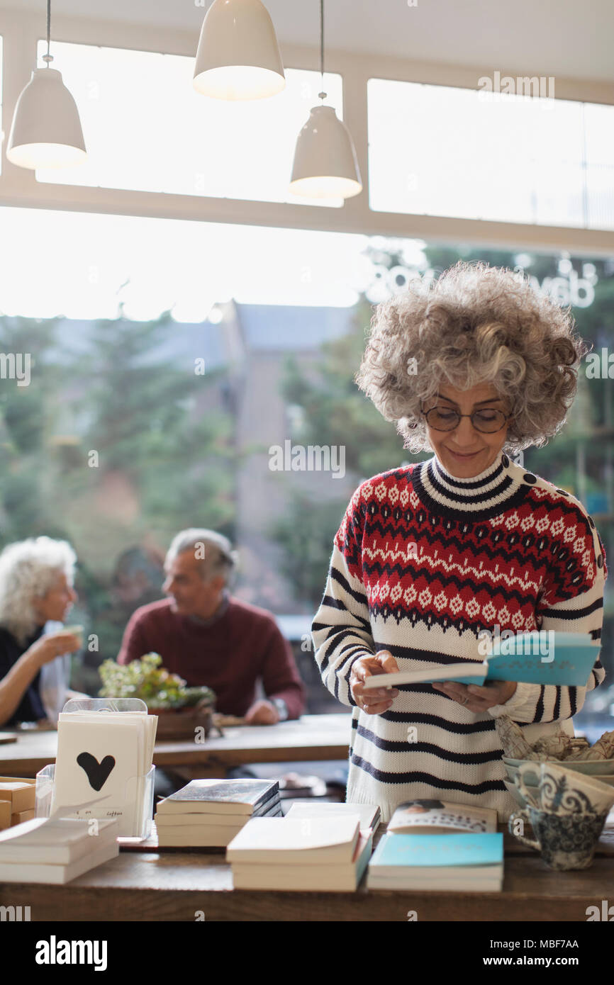 Standing looking down reading retail shopping consumerism book shop hi ...