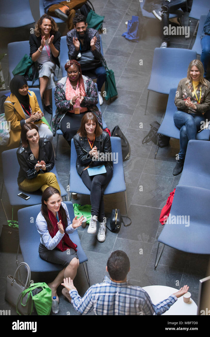 Conference audience clapping for male speaker Stock Photo - Alamy