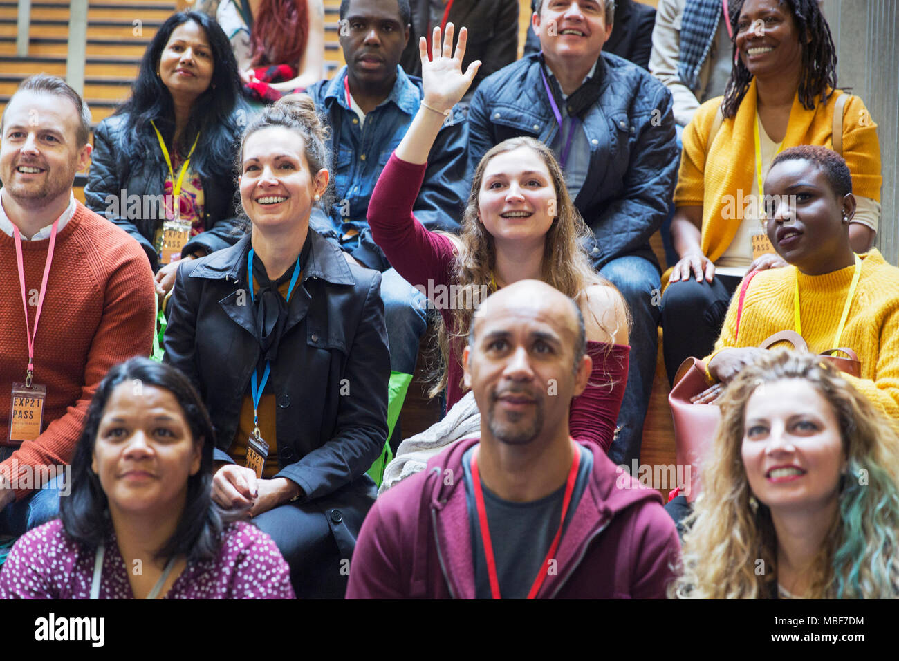 Woman raising hand participating hi-res stock photography and images ...