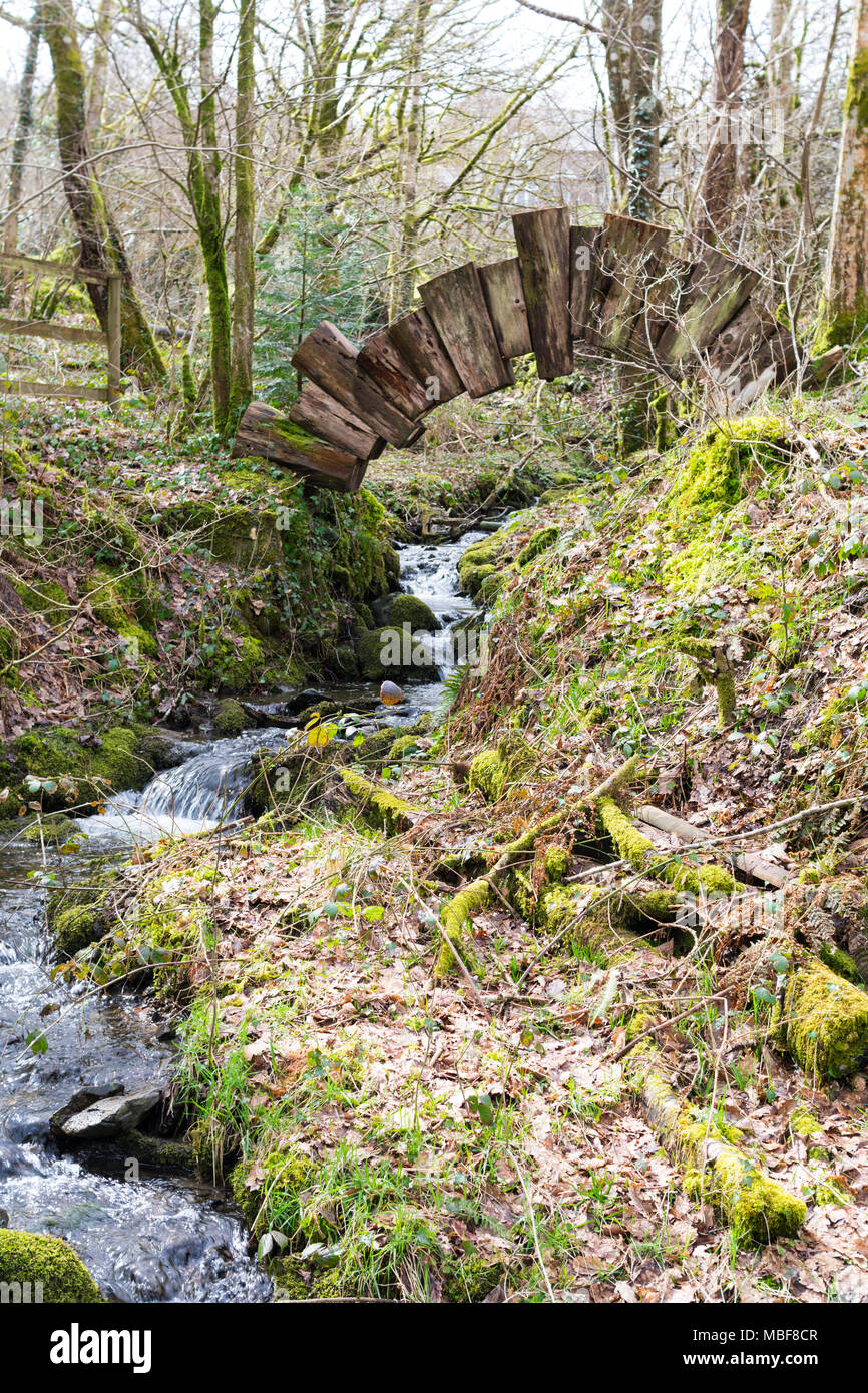 Wooden arch and gentle cascading stream with steep banks, near Lake ...