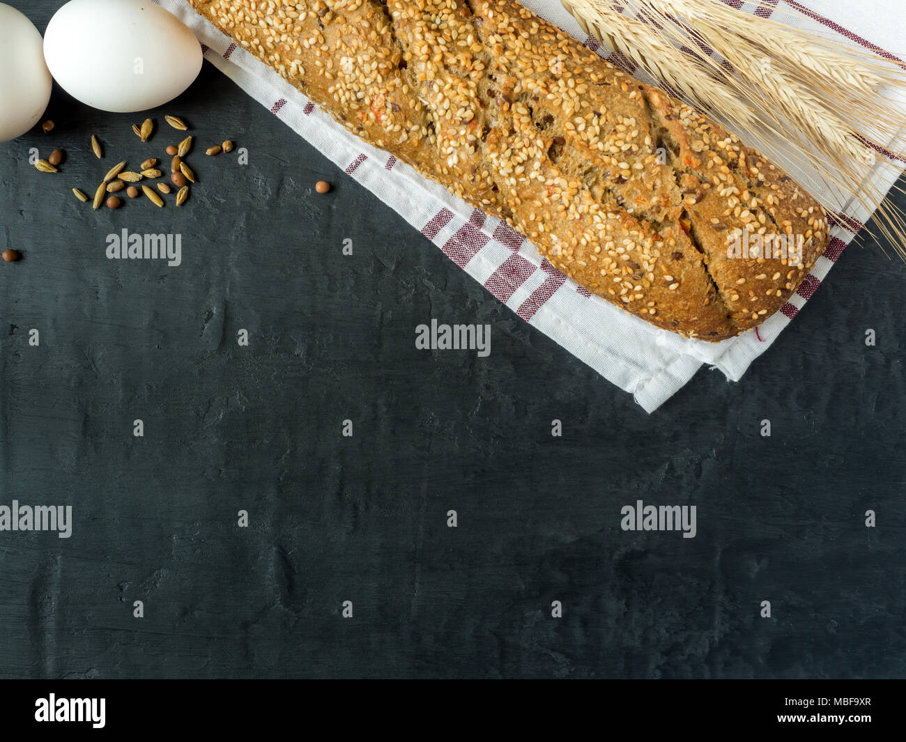Grain bread on dark background. The view from the top. Free space for ...