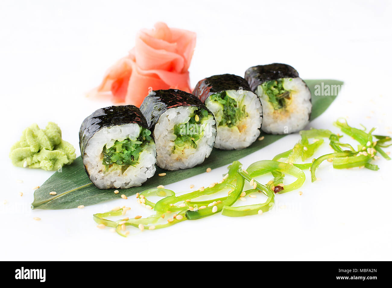 Delicious fresh mini-rolls with algae of Chukka on a banana leaf. Sushi ...