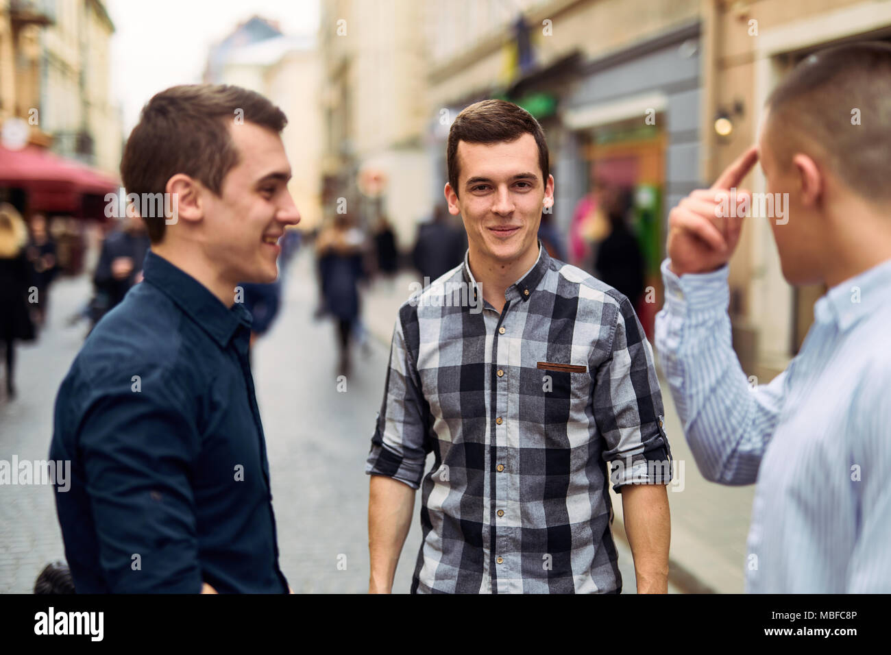 Three man talk on the street about business Stock Photo - Alamy