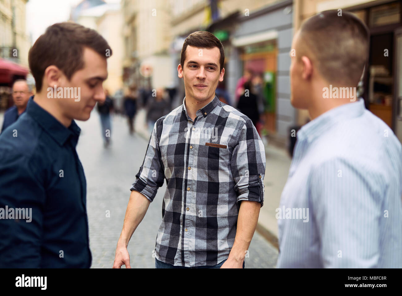 Three man talk on the street about business Stock Photo - Alamy