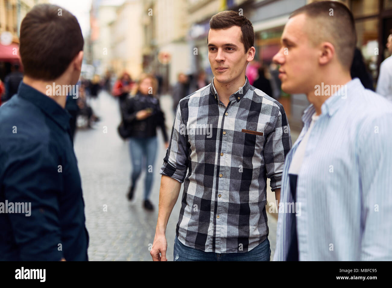 Three man talk on the street about business Stock Photo - Alamy
