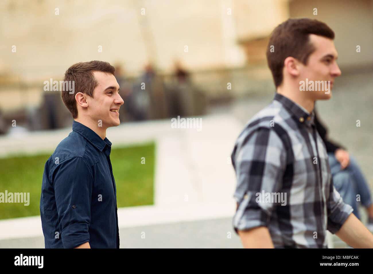 Two man walking on the street and look forward Stock Photo - Alamy