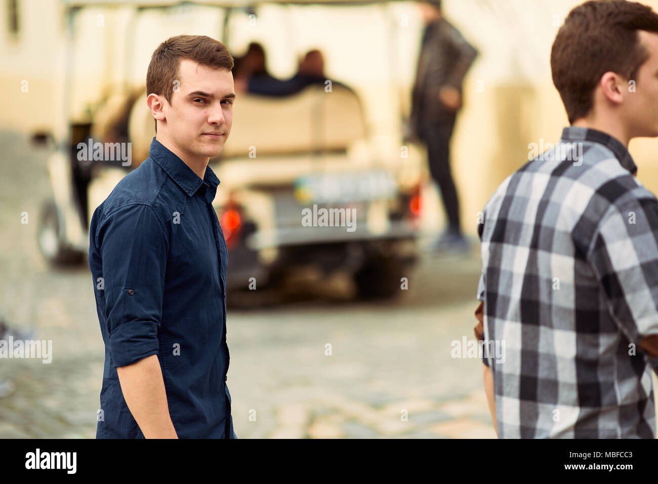 Two man walking on the street and look forward Stock Photo - Alamy