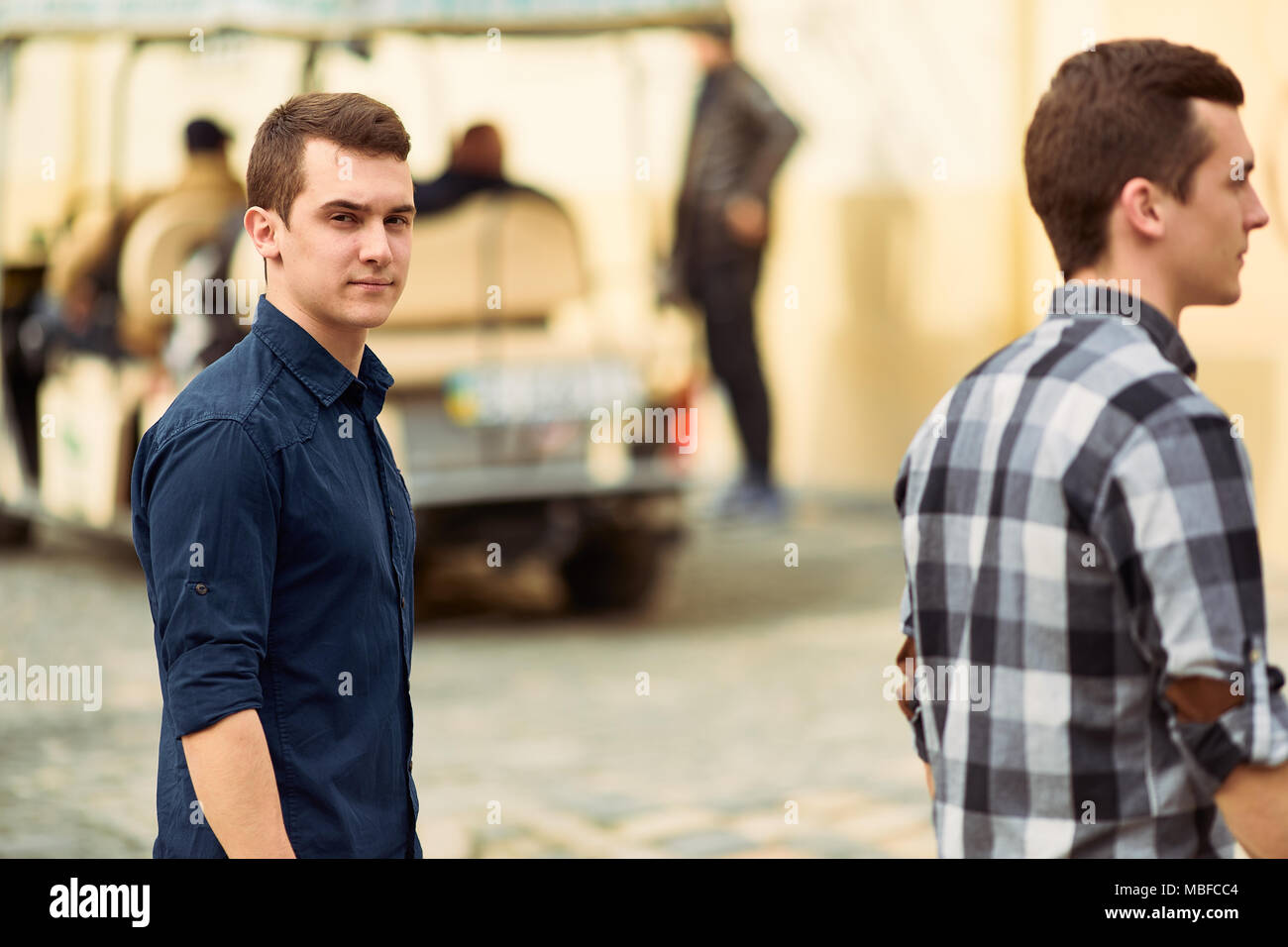 Two man walking on the street and look forward Stock Photo - Alamy
