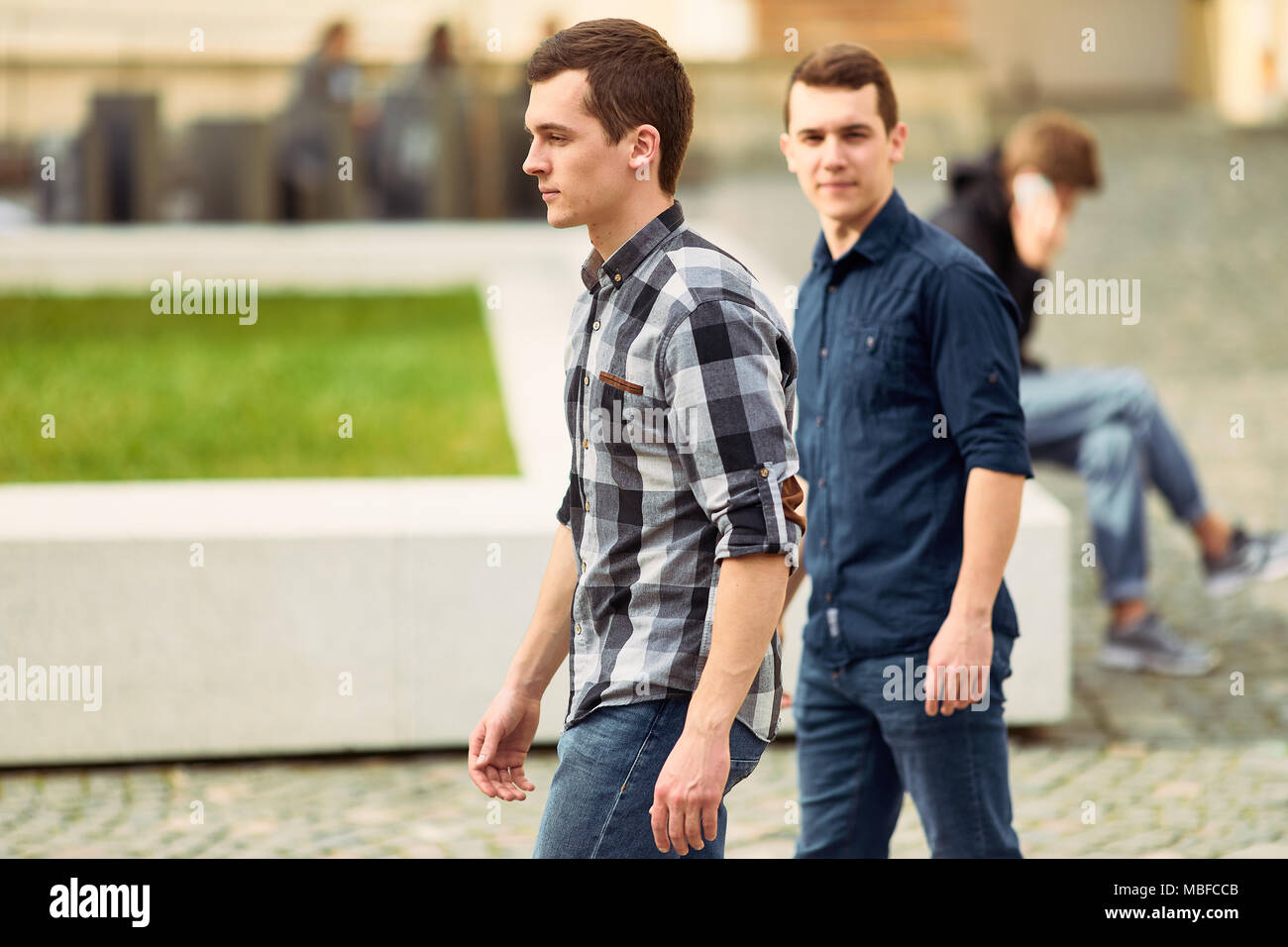 Two man walking on the street and look forward Stock Photo - Alamy