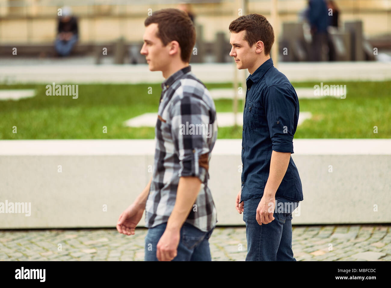 Two man walking on the street and look forward Stock Photo - Alamy