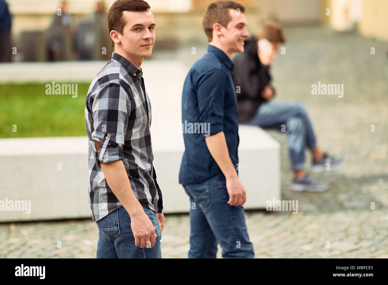 Two man walking on the street and look forward Stock Photo - Alamy