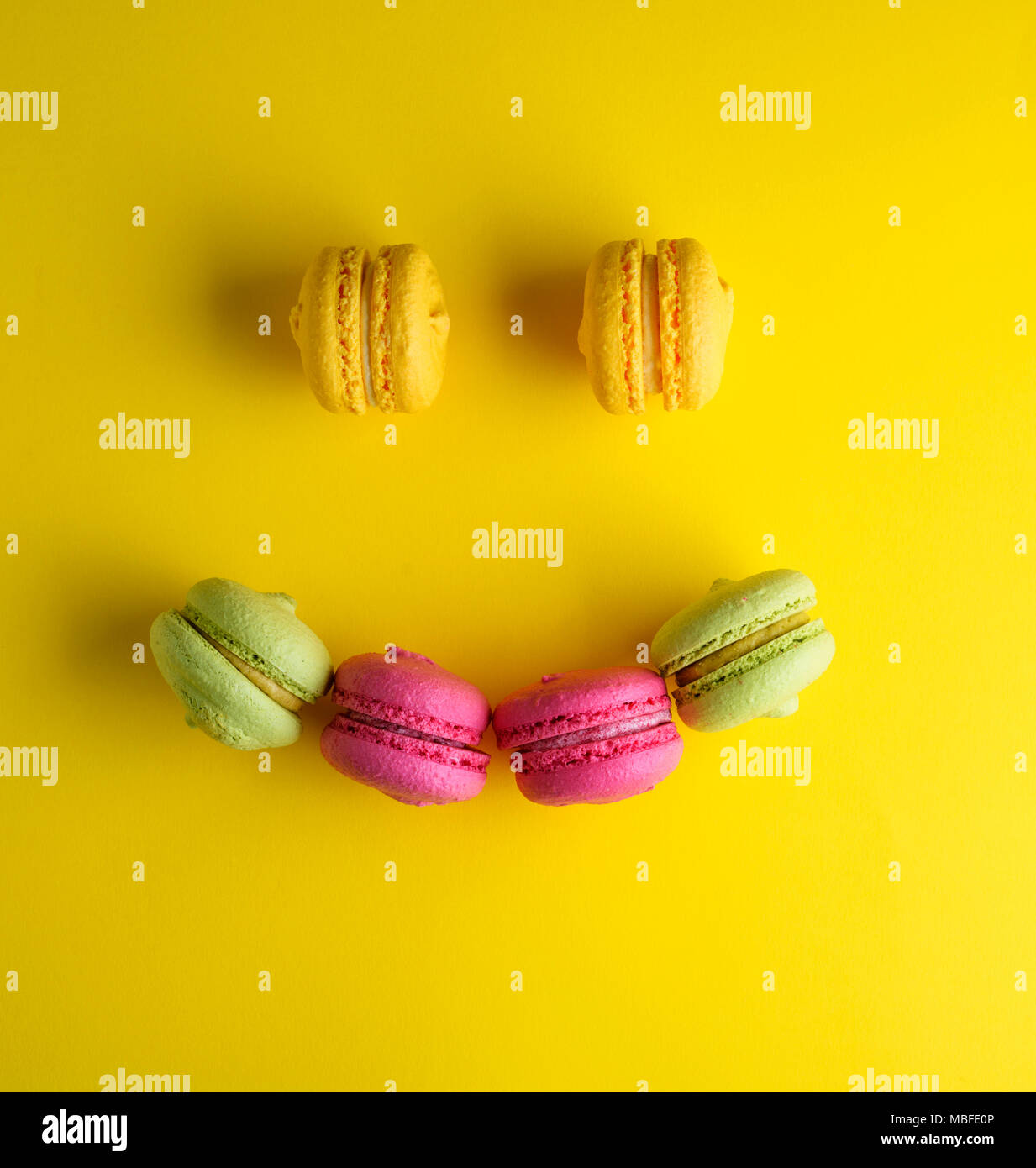 multicolored baked pastry with almond flour on a yellow background ...