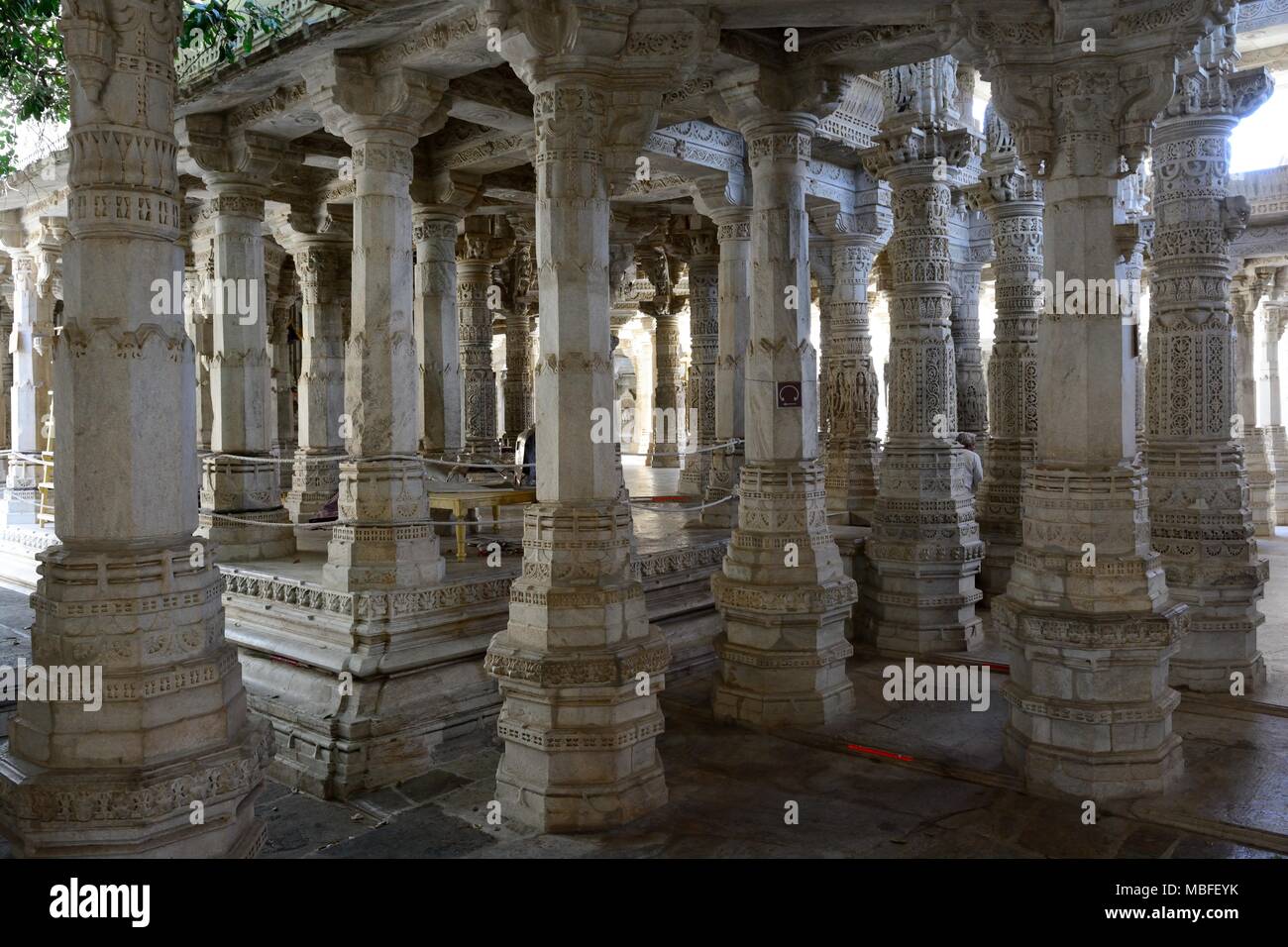 intricately carved marble pillars of the Adinath Temple depicting ...